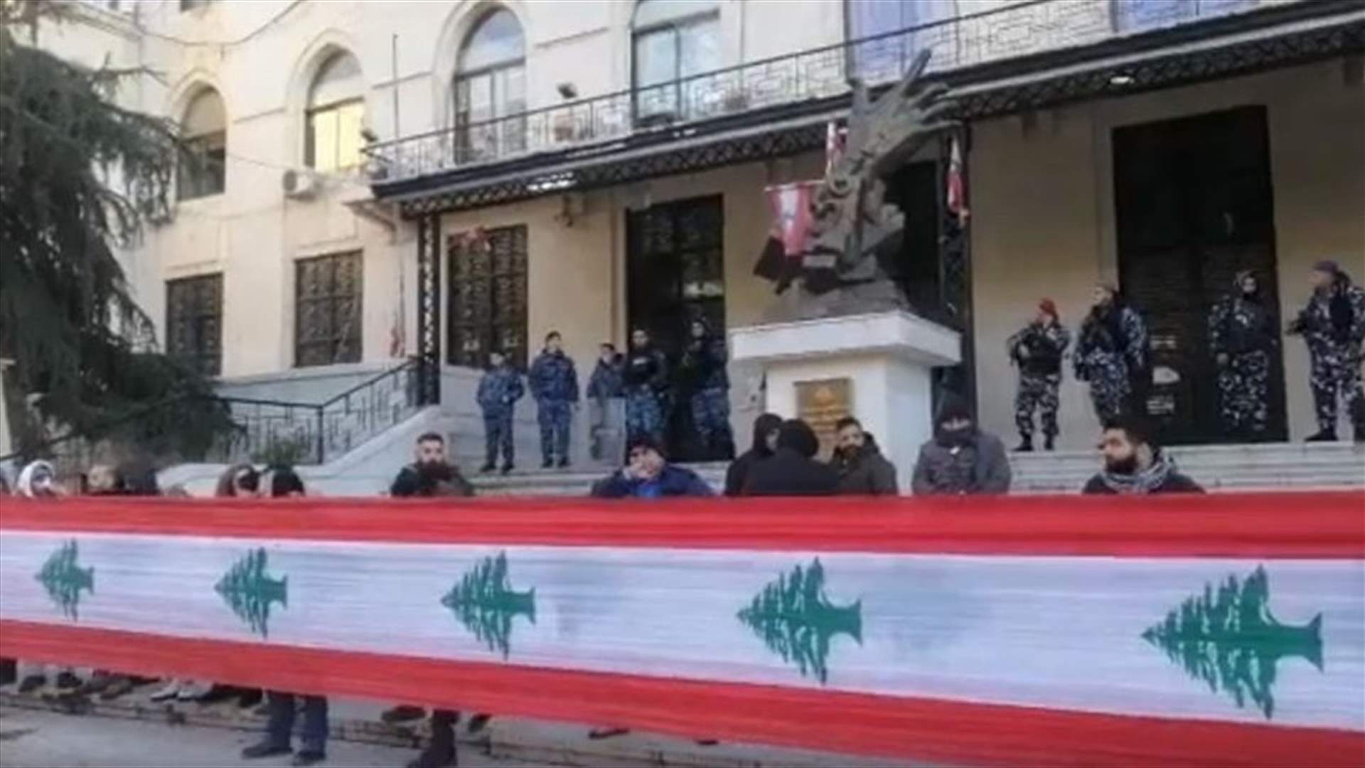 Protesters close entrance of Zahle Serail with a large Lebanese flag ...